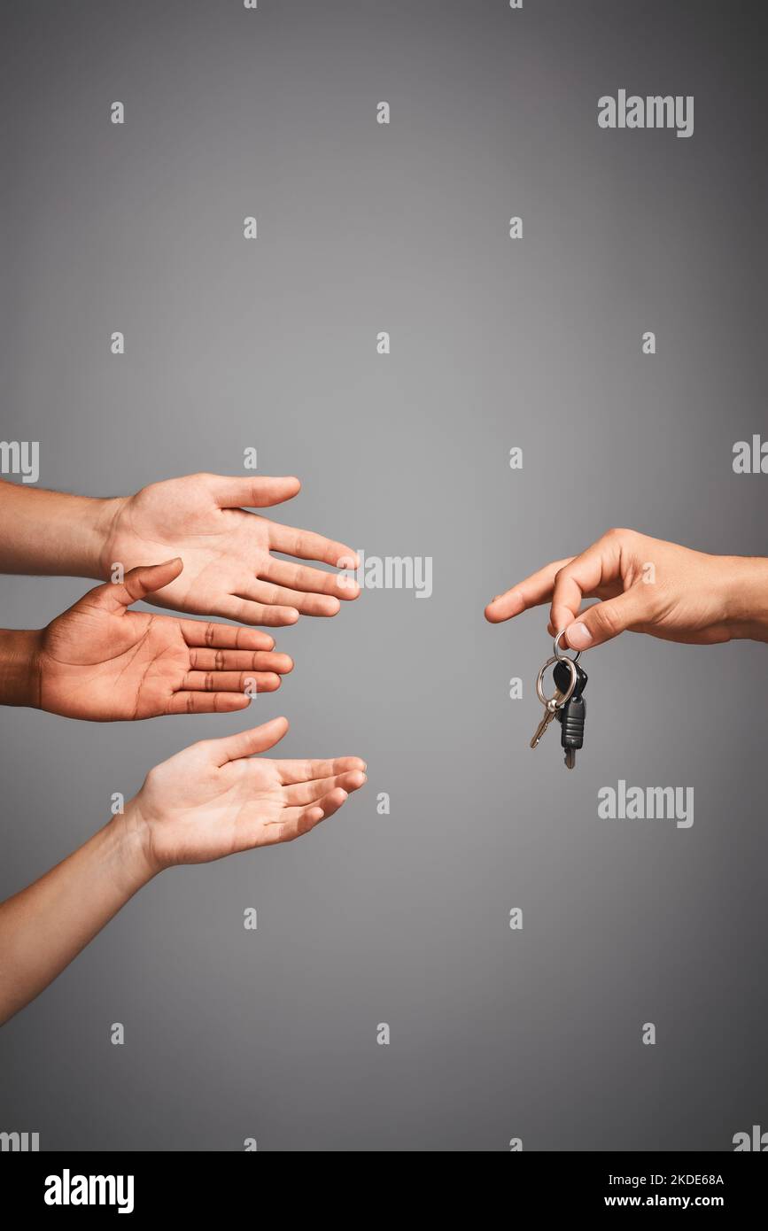 Drivers privileges up for grabs. Studio shot of unidentifiable hands ...