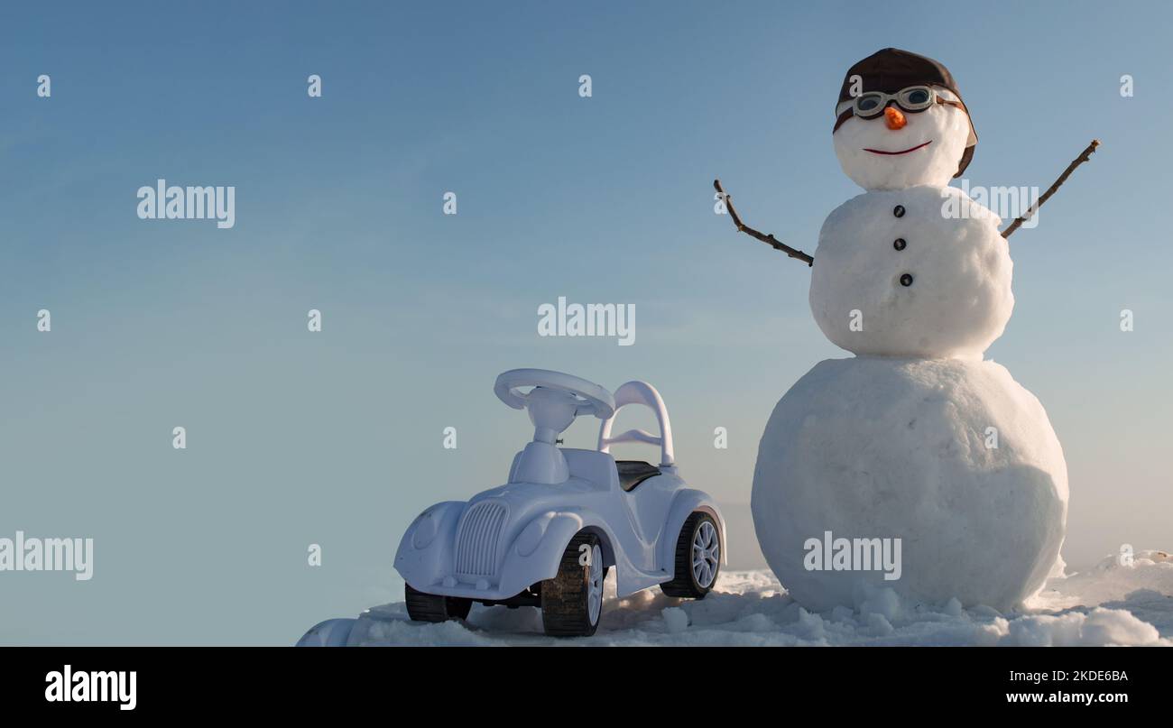 Snowman driver on the snow outdoor background. Christmas banner with ...