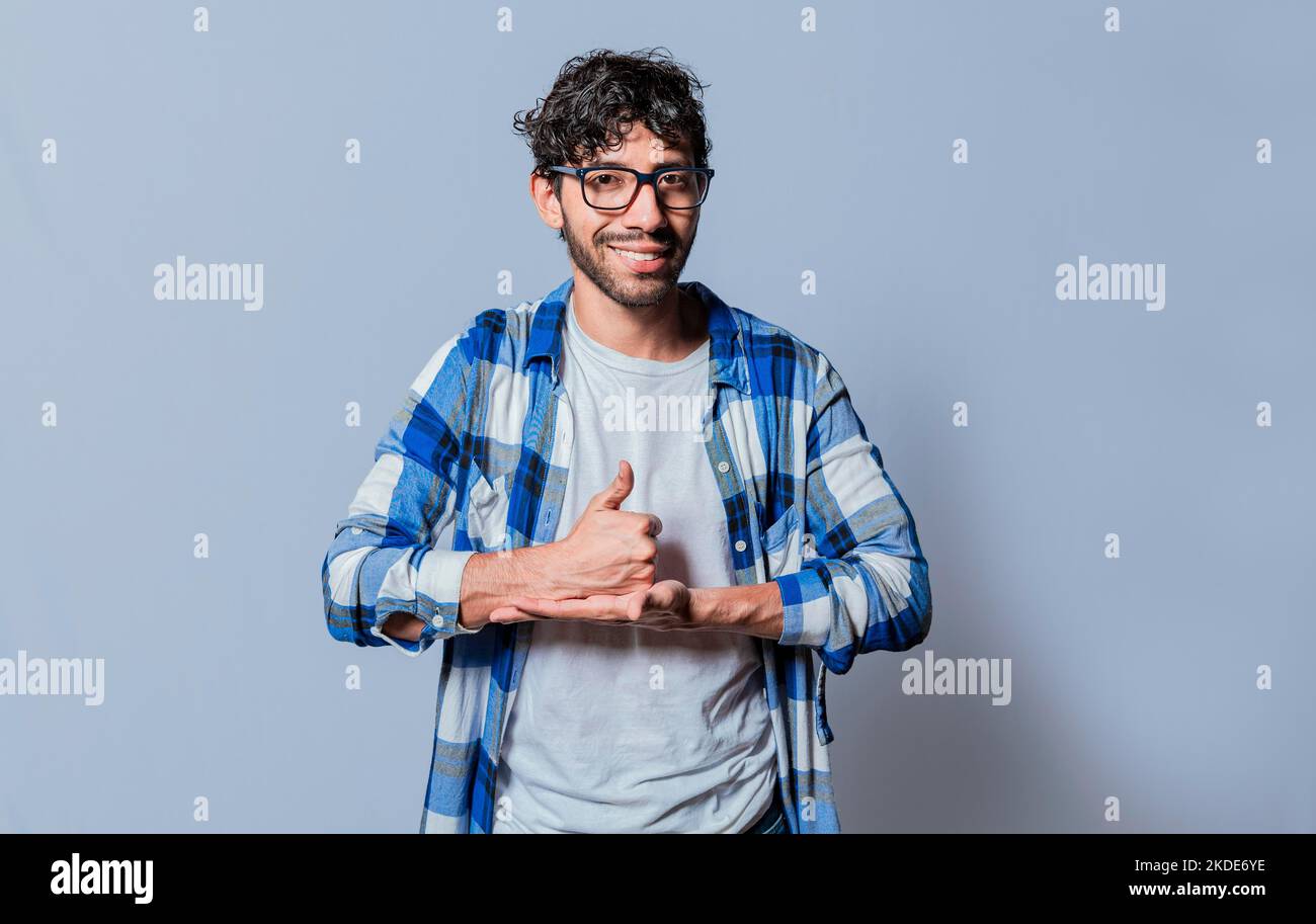 Person gesturing help with hands in sign language, Young man showing ...