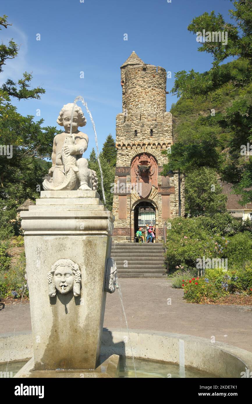 Ornamental fountain with putto and fish figure and war memorial, water ...