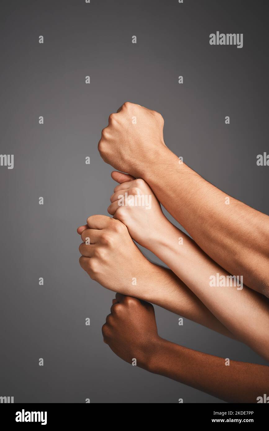 Finding power in unity. Studio shot of unidentifiable hands making ...