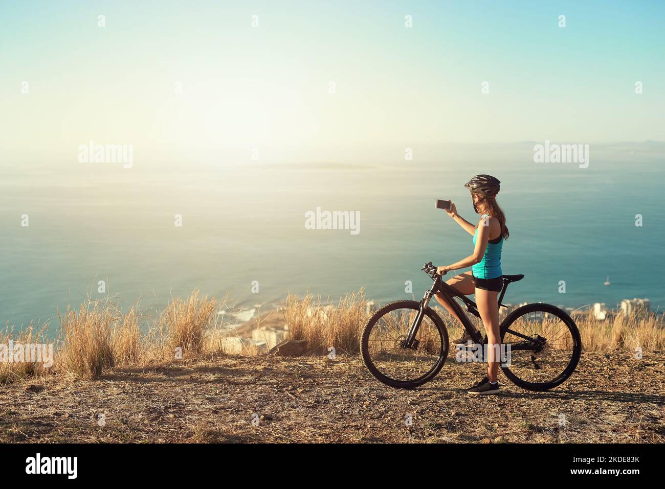 Theres a beauty to mountain biking. a young woman taking a picture of ...