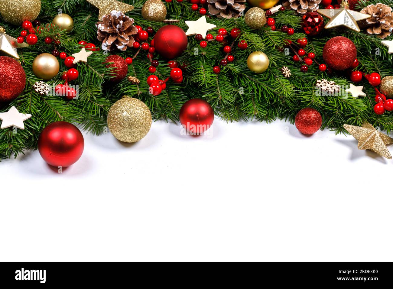 Christmas tree branches with red baubles, golden stars, pine cones ...