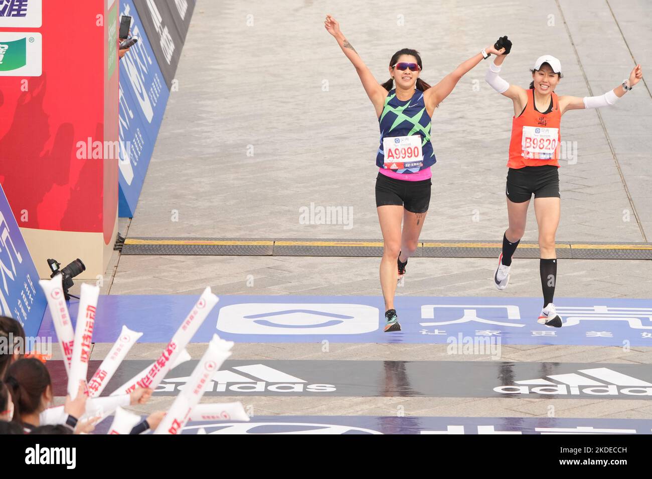 Beijing, China. 6th Nov, 2022. Two runners cross the finish line during ...