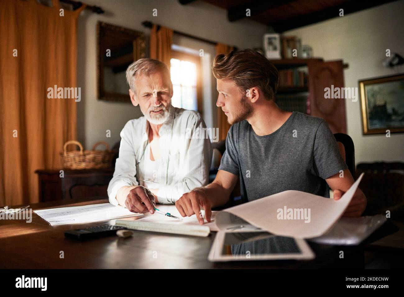 They always work well together. two men working on a project together ...