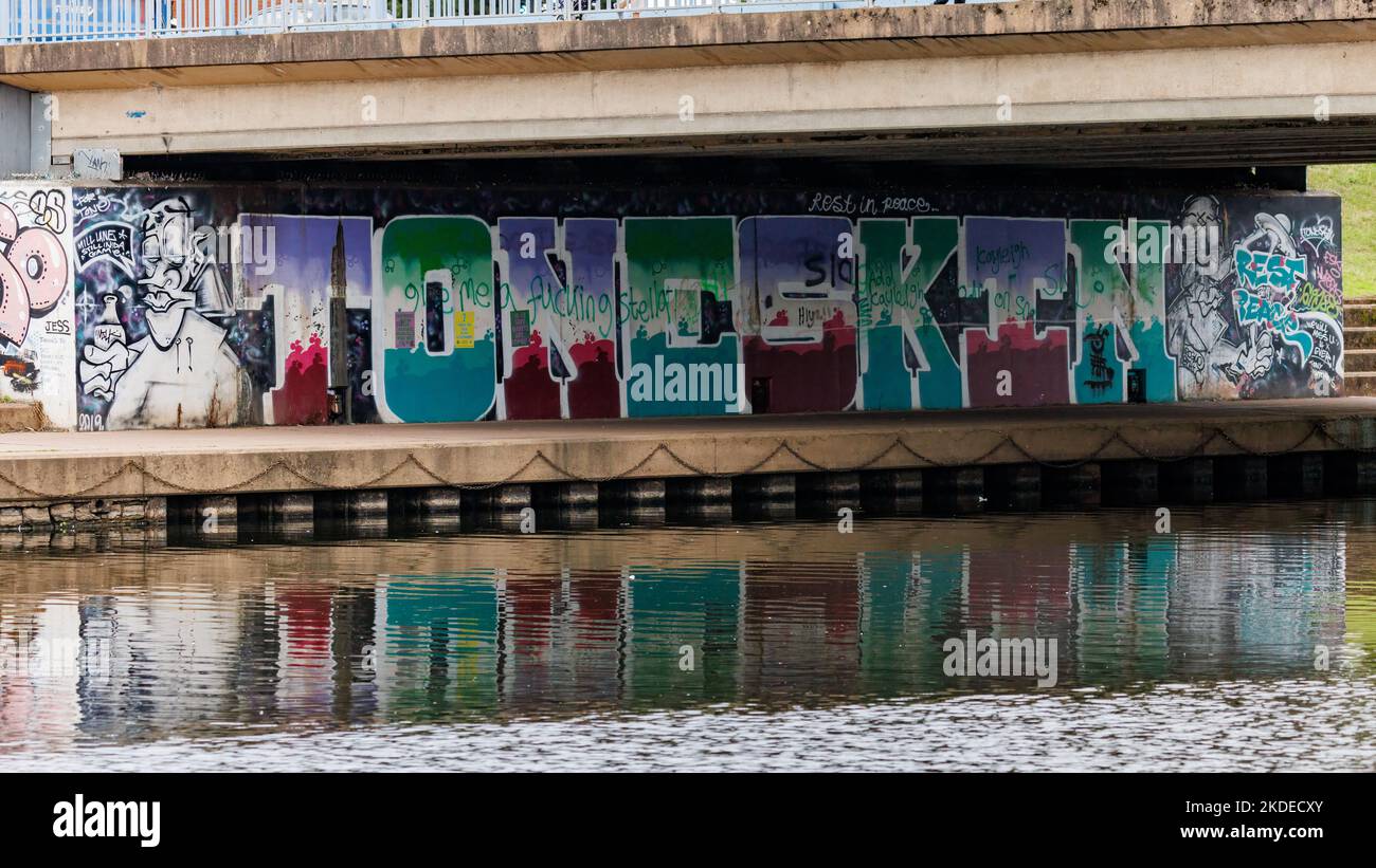Graffiti under bridge with reflection in river in Exeter, UK Stock ...