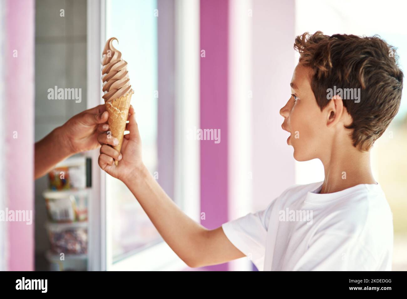 Wow, that looks delicious. a happy young boy getting an ice-cream cone ...