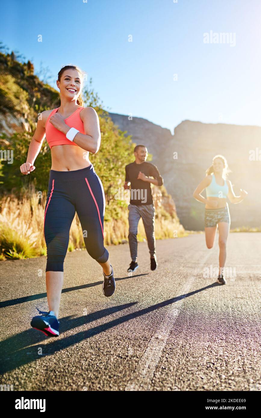 Sprinting towards their fitness goals. a fitness group out for a run ...
