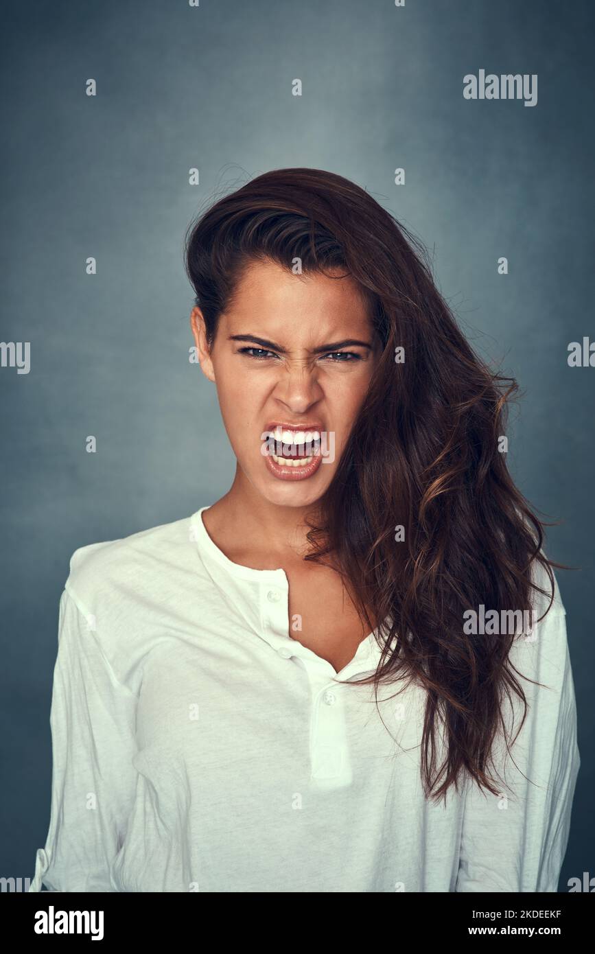 Get it all off your chest. Portrait of a beautiful young woman pulling ...