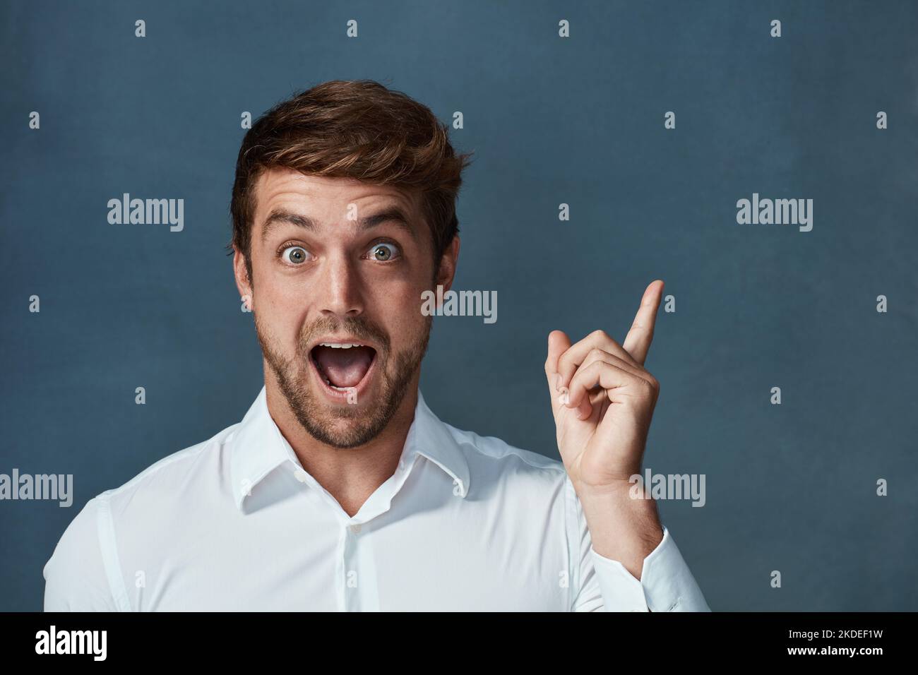 How exciting is this. Studio portrait of a handsome young man pointing ...