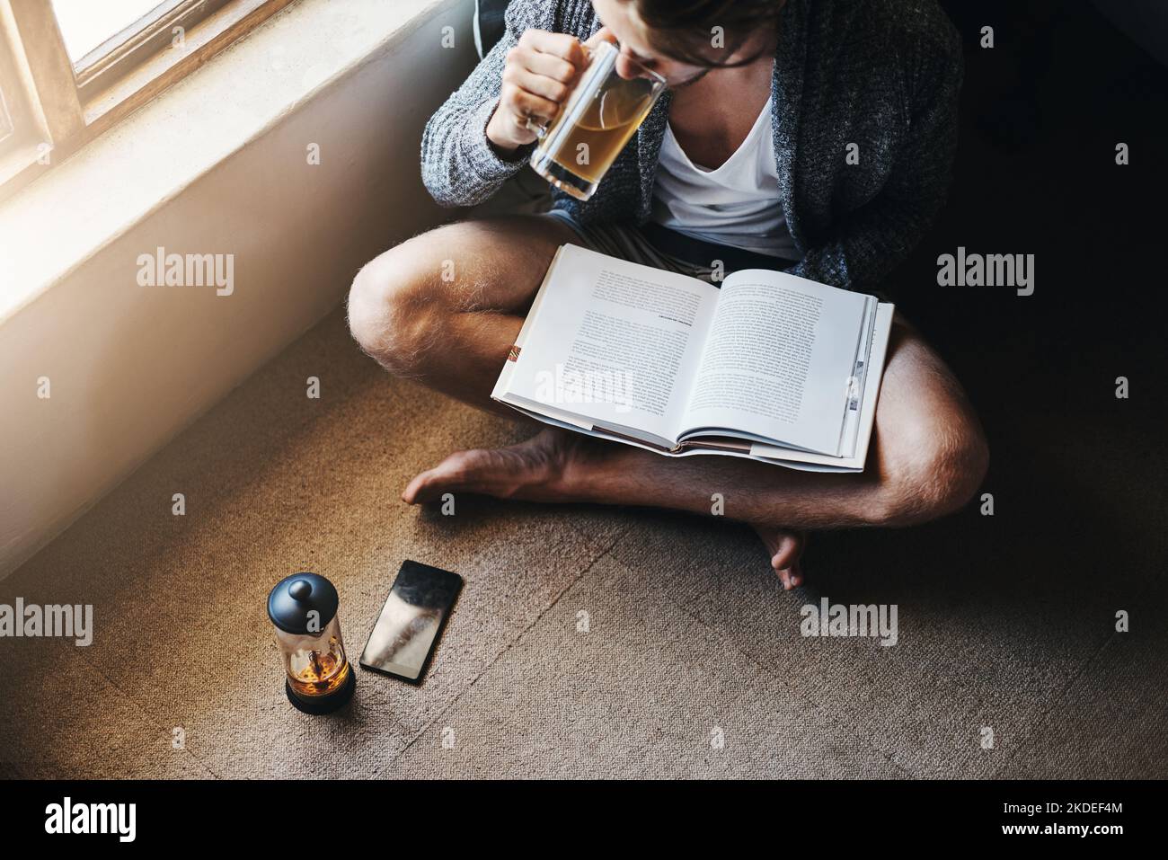 The best company to keep is your own. High angle shot of a young man ...