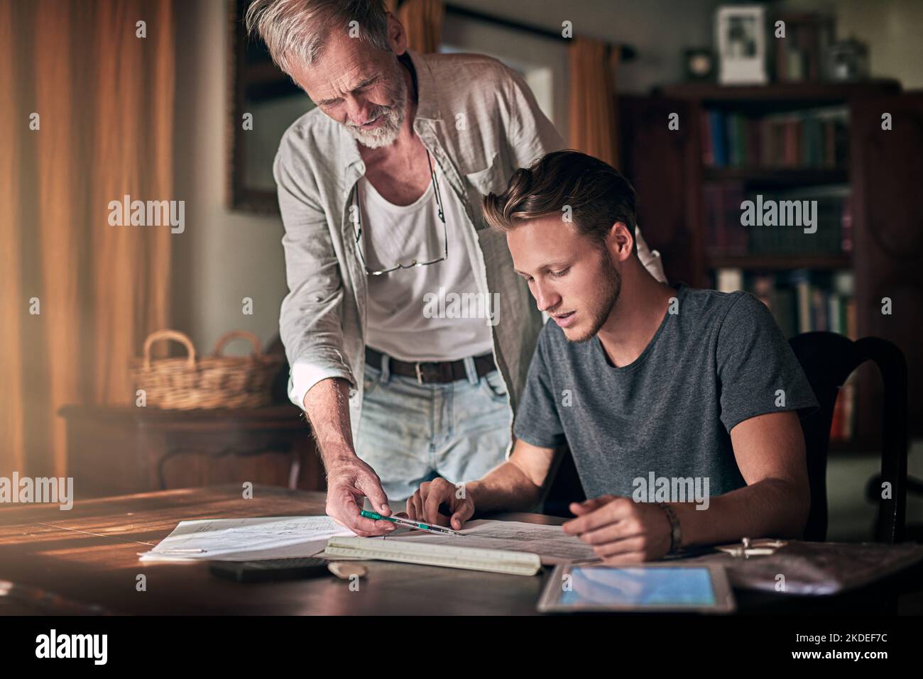 Dads criticism is always constructive. a father and his son working on ...