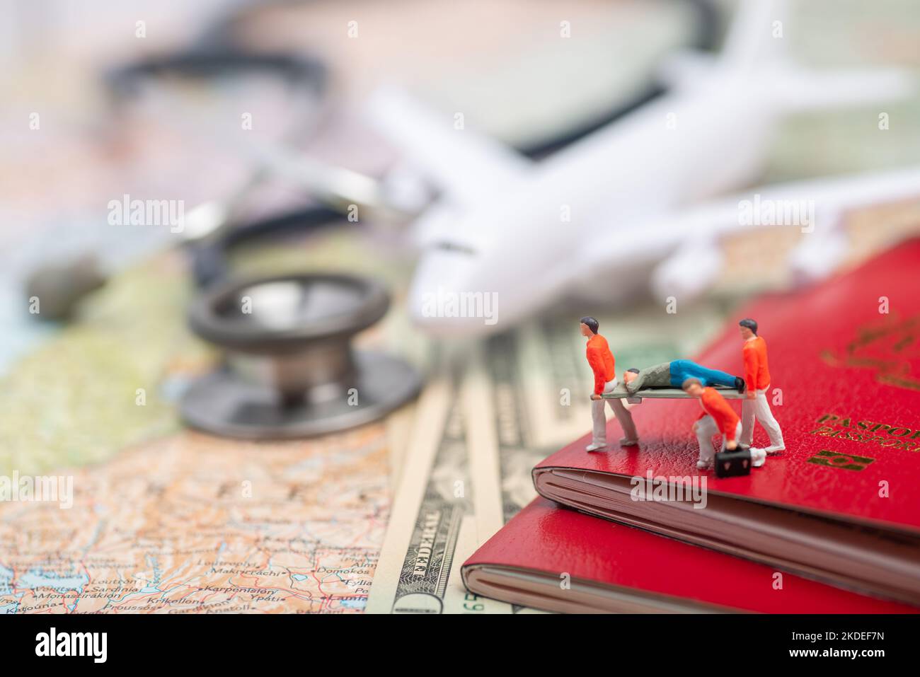 Miniature figures of paramedic personnel attending sick person in a ...