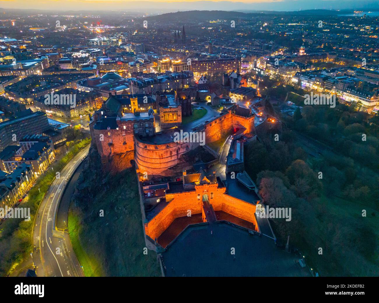 Aerial view at dusk of Edinburgh Castle illuminated in red, Edinburgh ...