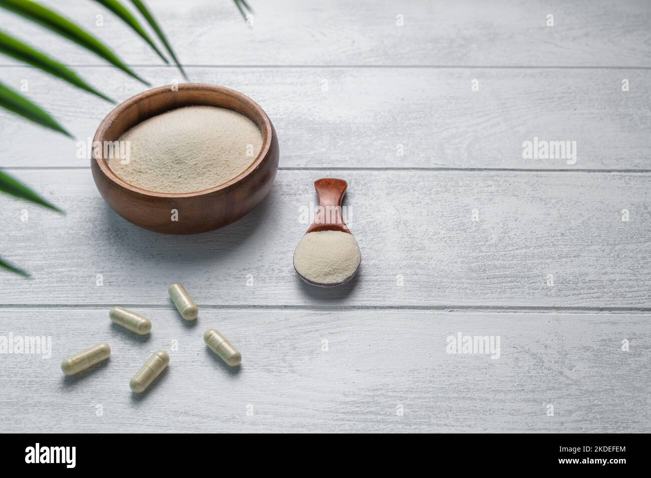 Collagen powder in bowl and spoon on wooden white background. Extra ...