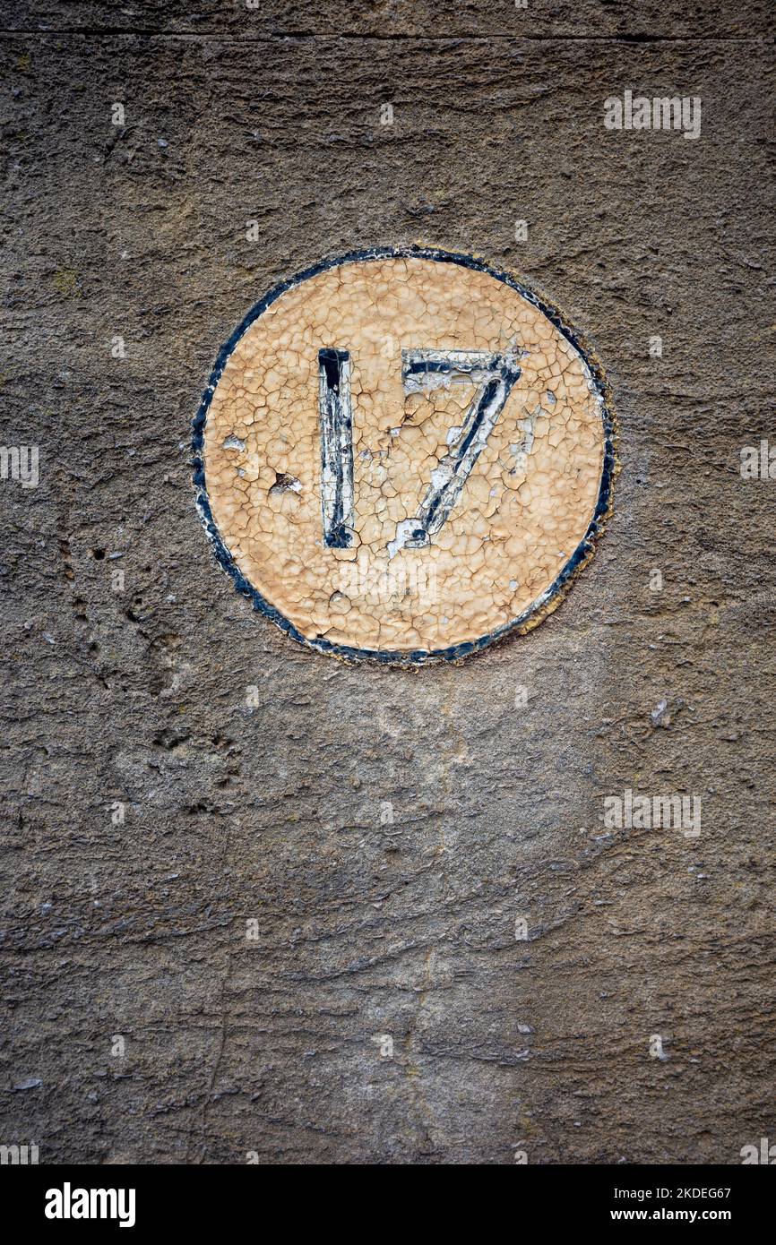 Number 17 house number on a stone wall Stock Photo - Alamy