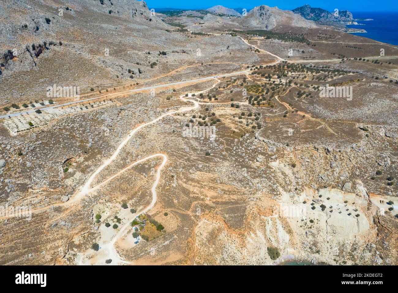 Spectacular aerial view with serpentine off-road track to top of ...