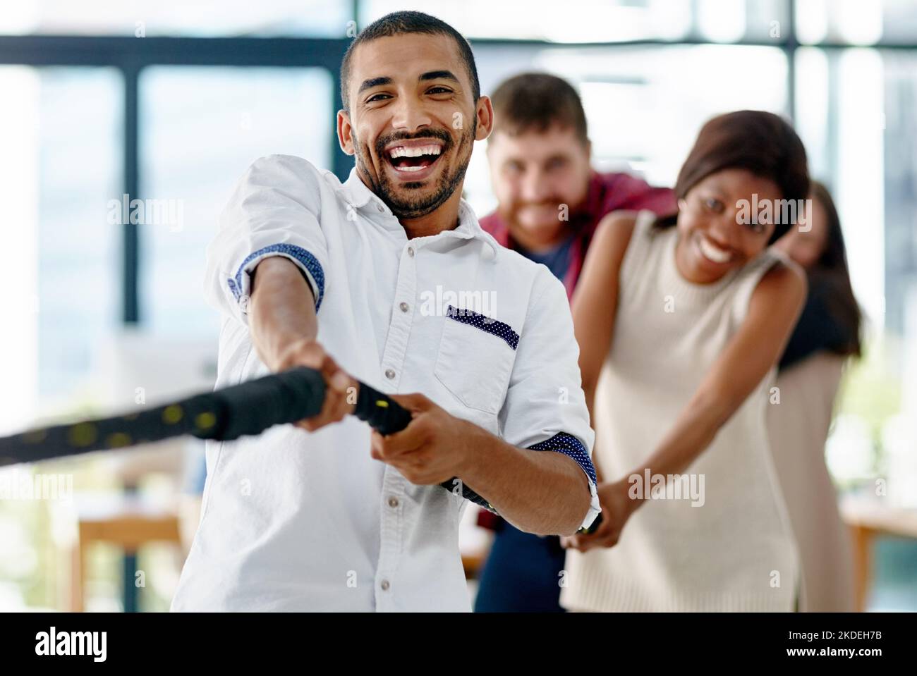 Were winning. a group of young designers pulling on a rope during tug ...