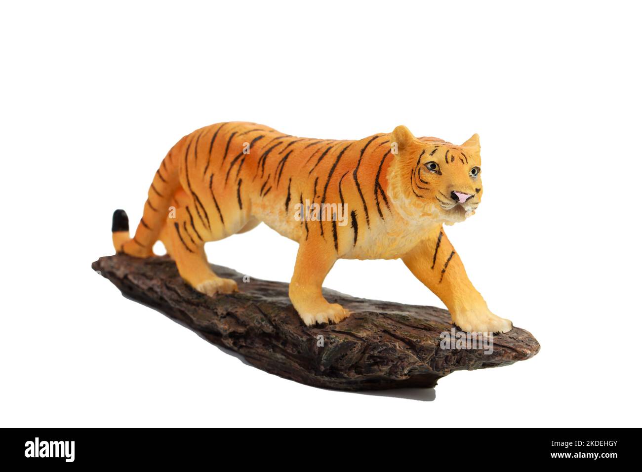 A tiger figurine made of plastic. Isolated over white background. Close ...