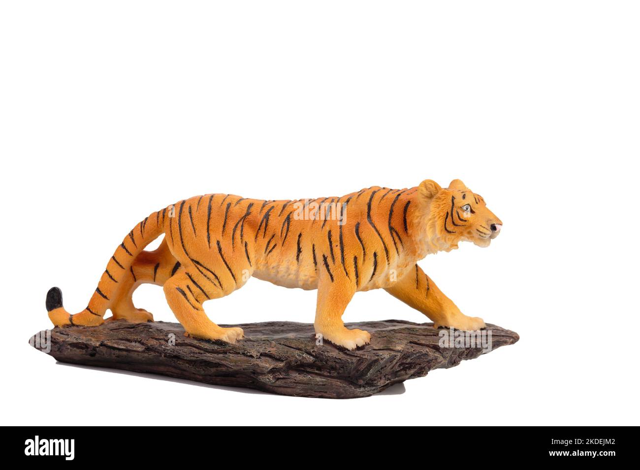 A tiger figurine made of plastic. Isolated over white background. Close ...