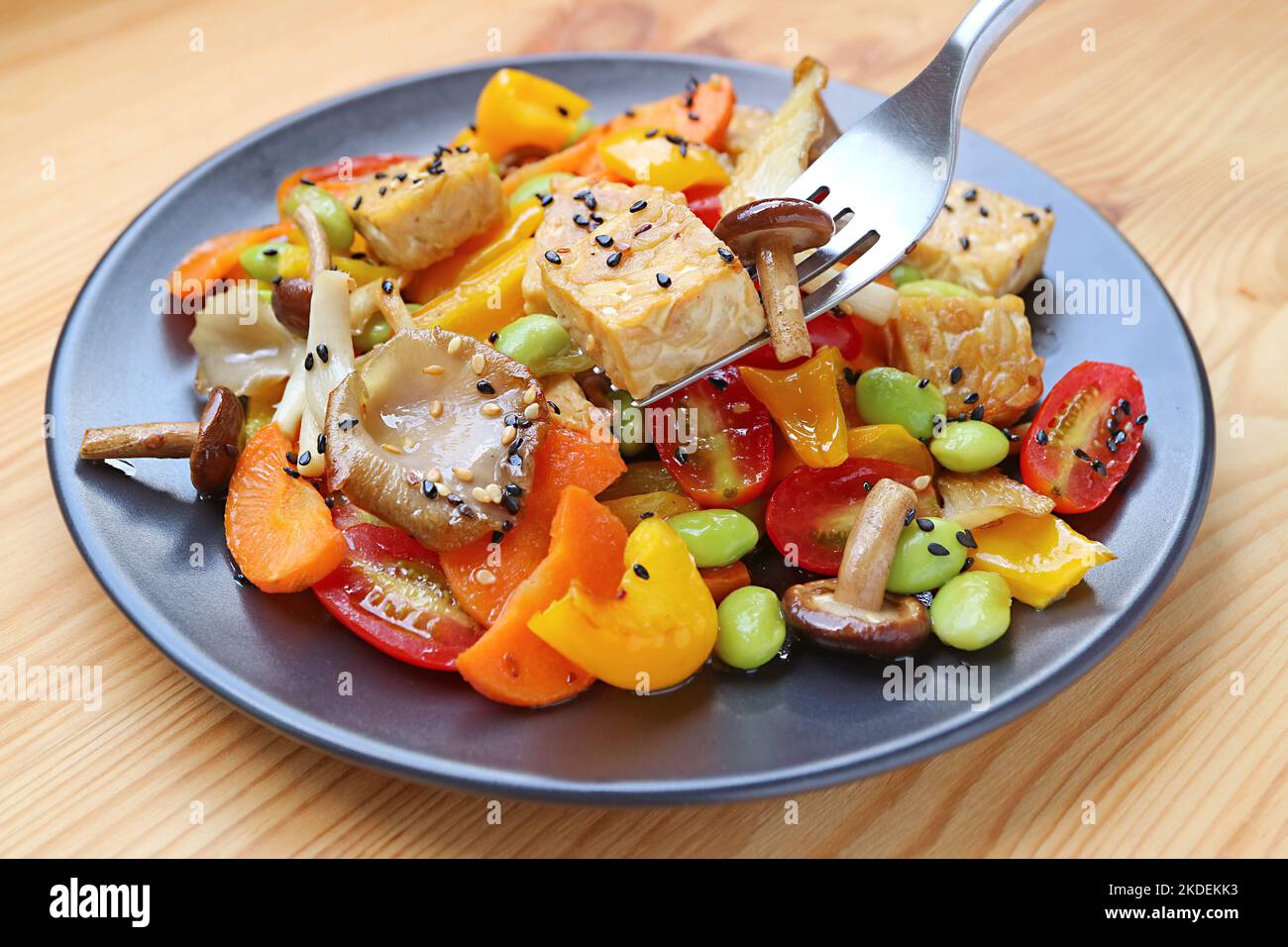 Fork Scooping Velvet Pioppini Mushroom and Roasted Tempeh Cubes from ...