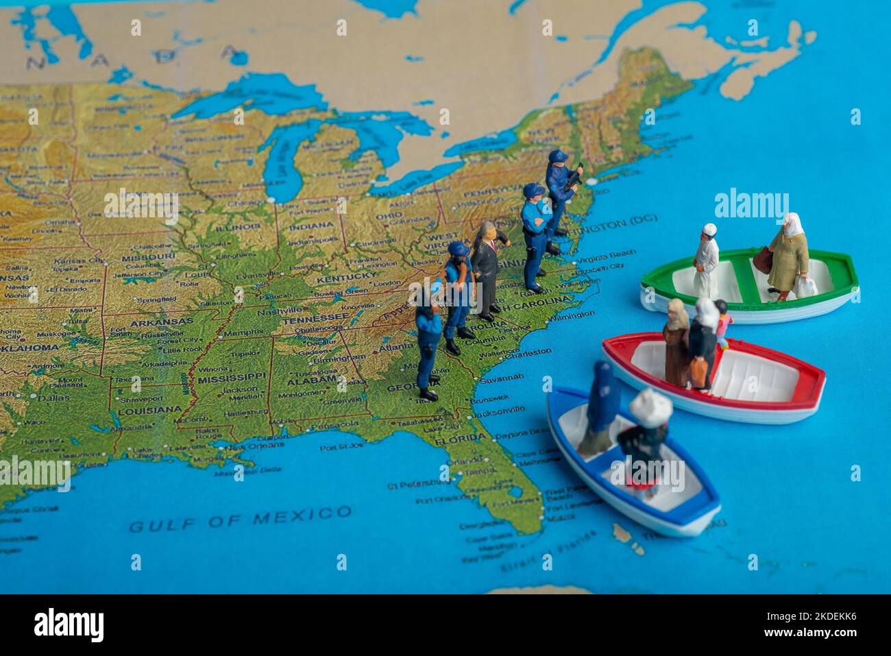 Miniature people concept of Middle Eastern people arrive by boat to the ...