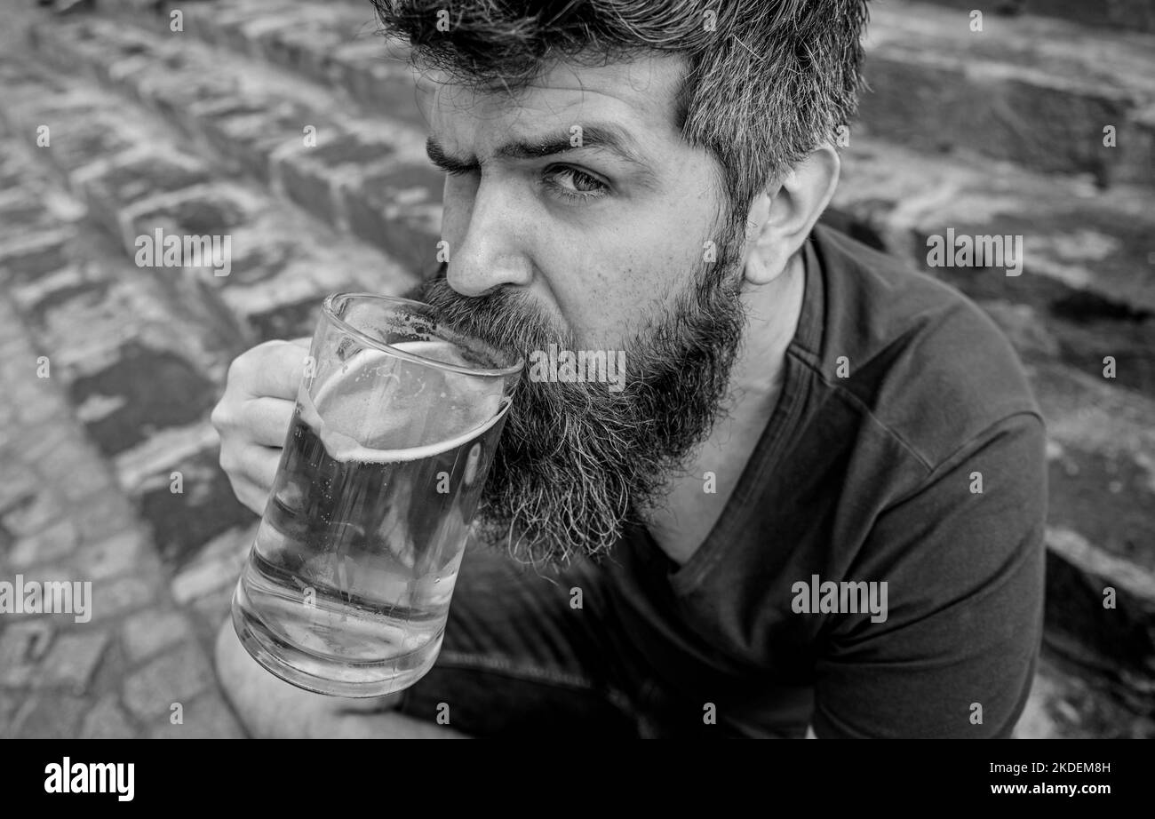 Guy having rest with cold draught beer. Hipster on calm face drinking ...