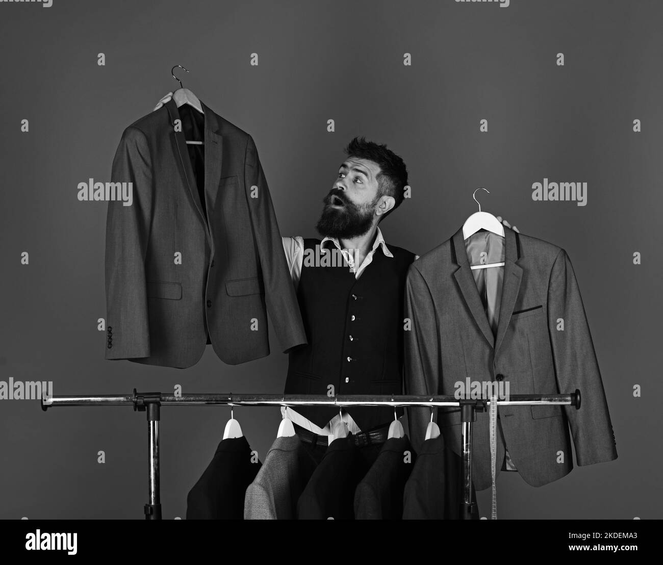 Designer makes choice near clothes hangers. Tailoring and design Stock ...