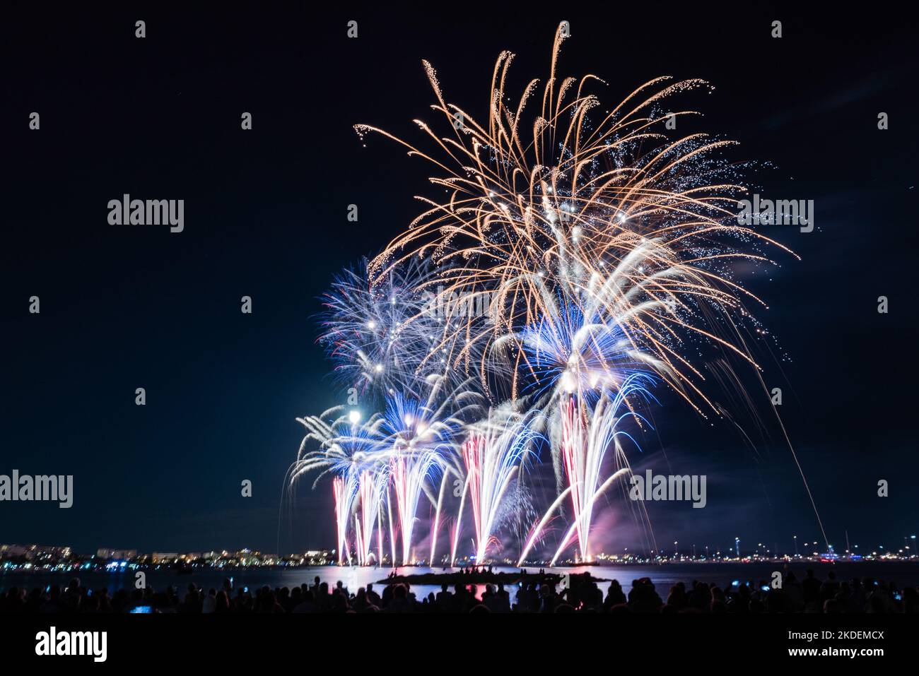 Scenic fireworks glowing in the night for the 14th of July celebrations ...