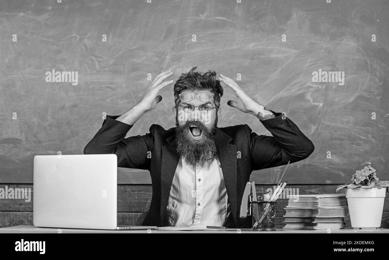 What stupid thought. Man bearded teacher aggressive expression sit ...