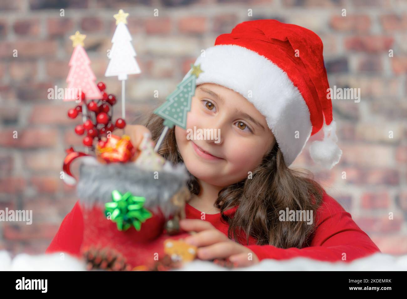 Child in Santa red cloth with red Santa boot Stock Photo - Alamy