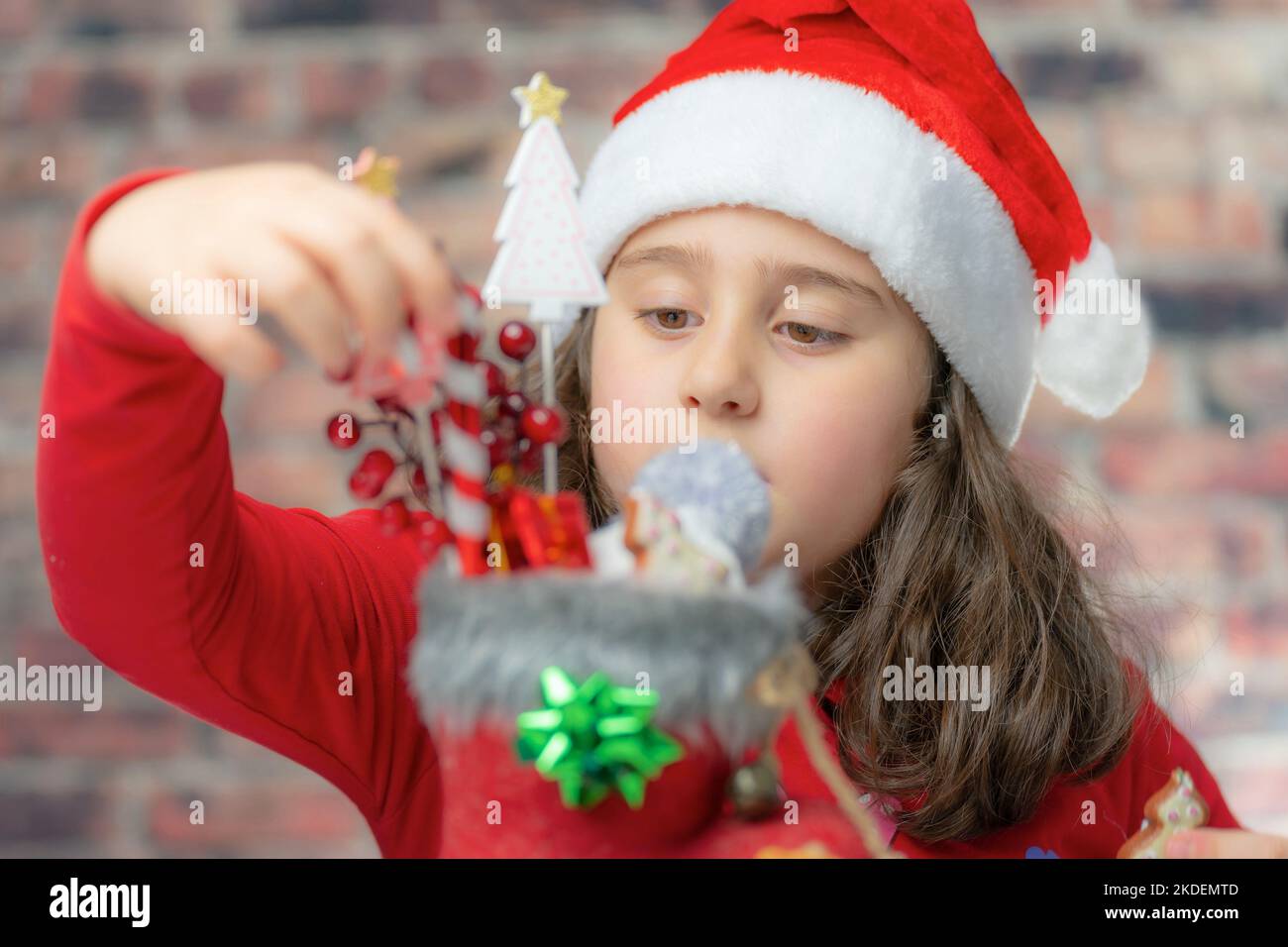 Child in Santa red cloth with red Santa boot Stock Photo - Alamy