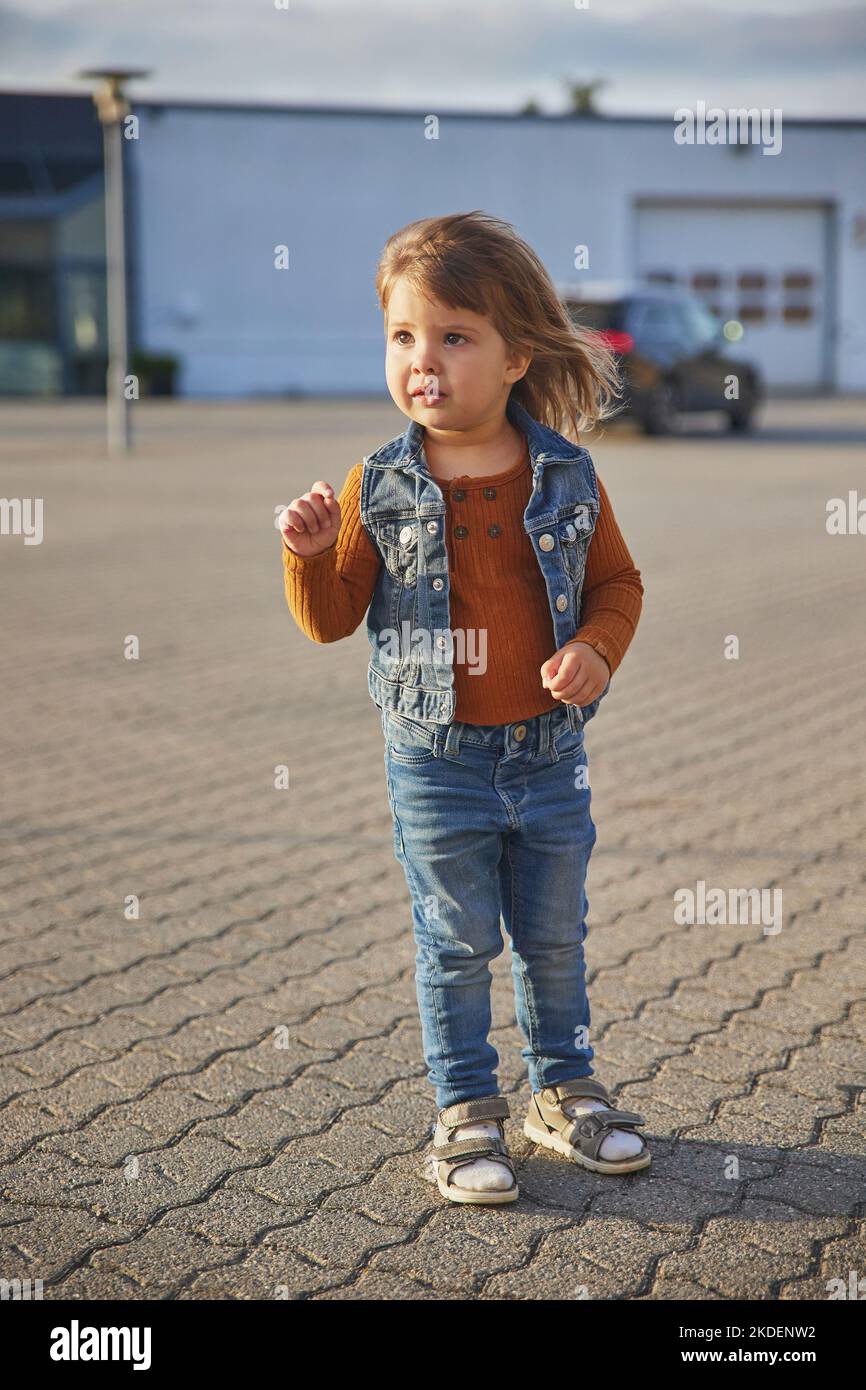 Stylish child playing in the parking lot Stock Photo - Alamy