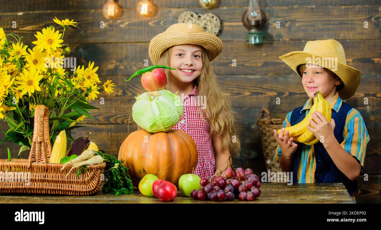 Children play vegetables wooden background. Elementary school fall ...