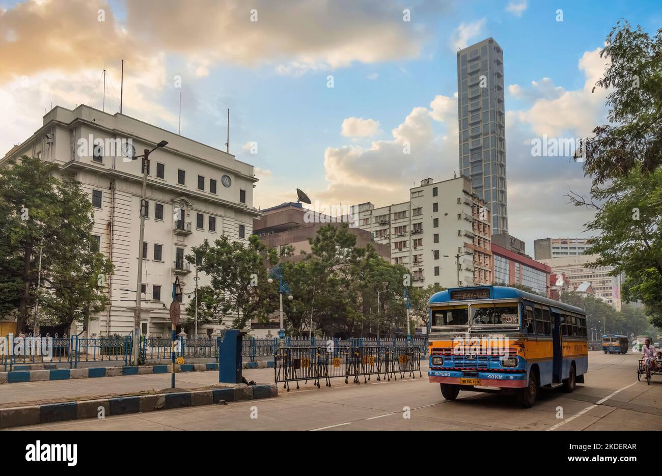 City road with public transport bus and view of office buildings at ...