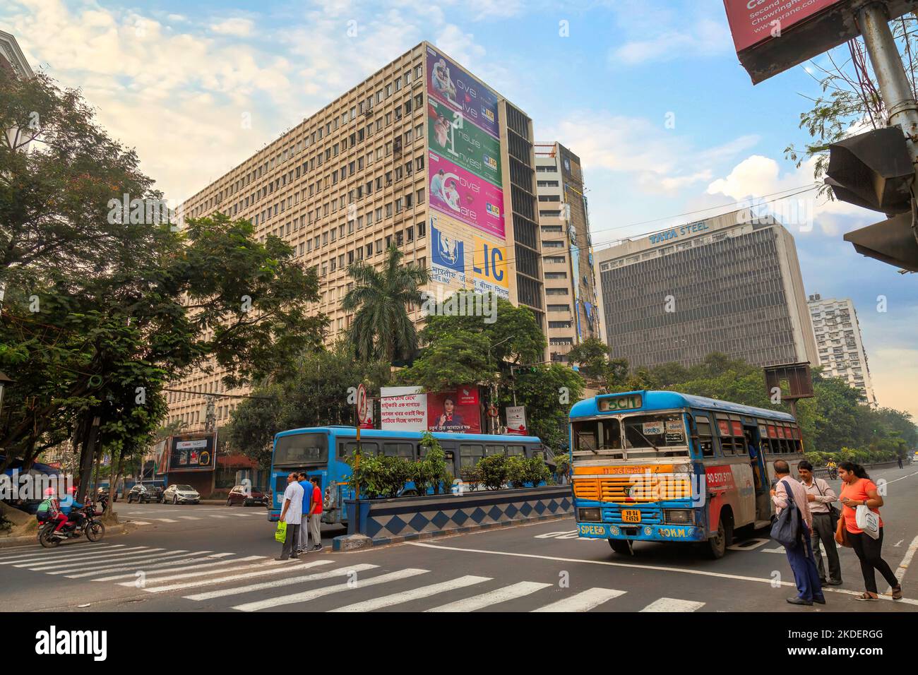 City road with public transport bus and view of office buildings at ...