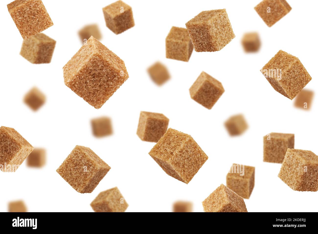 Falling Brown cane sugar cubes isolated on white background, selective ...