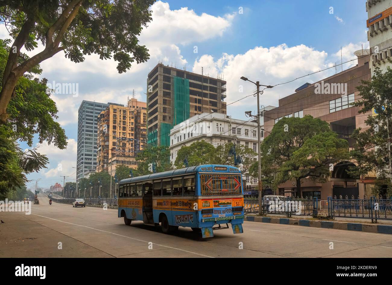 City road with public transport bus and view of office buildings at ...