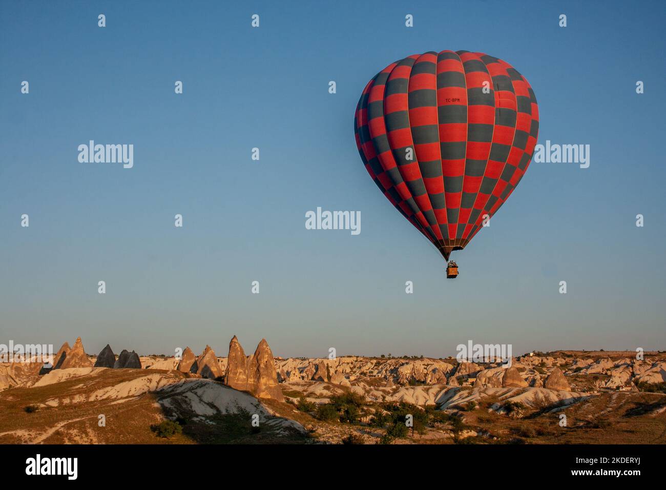 hot air balloons rise over the chimneys rock formation, Cappadocia ...