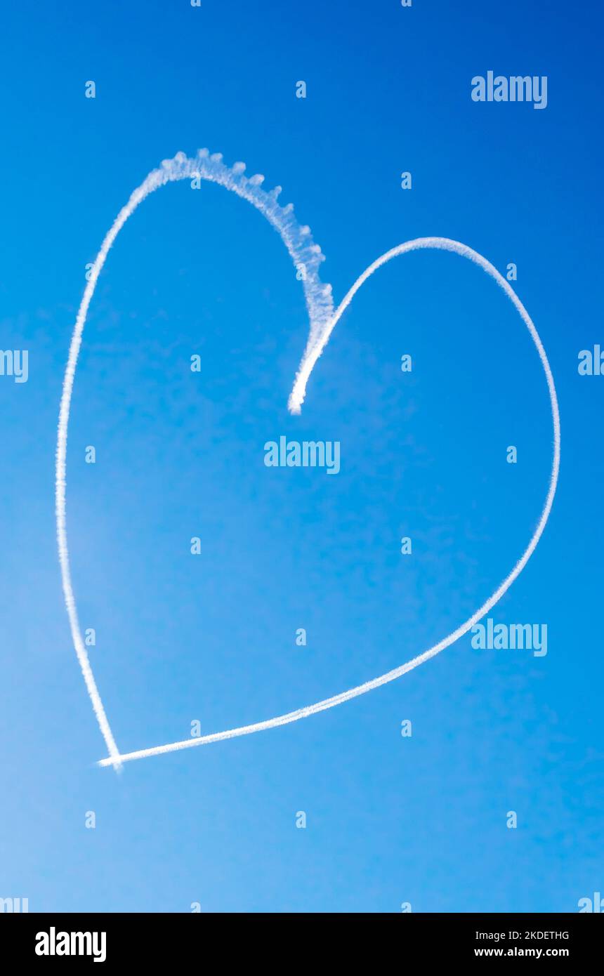 Romantic heart written in the blue sky by a small aircraft Stock Photo ...