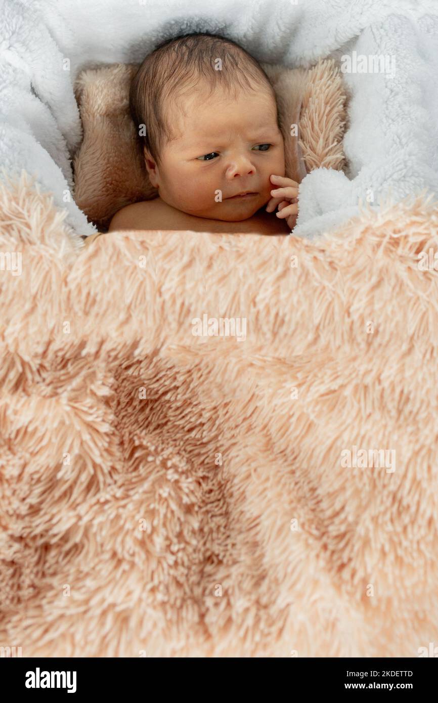 Two week old newborn baby boy sleeping in a vintage wooden box. Shot in ...