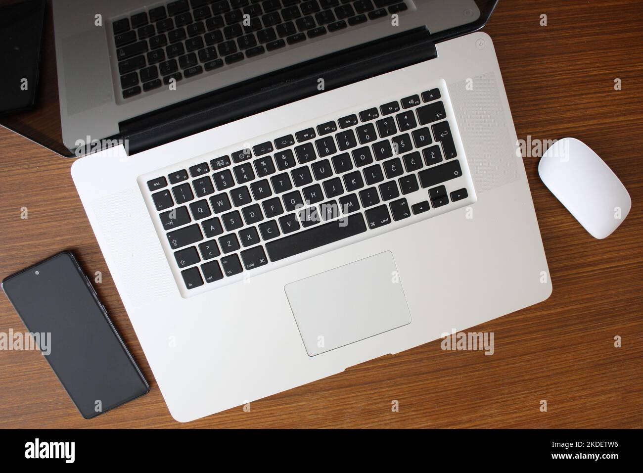 Office workspace with laptop, mouse, and mobile phone Stock Photo - Alamy