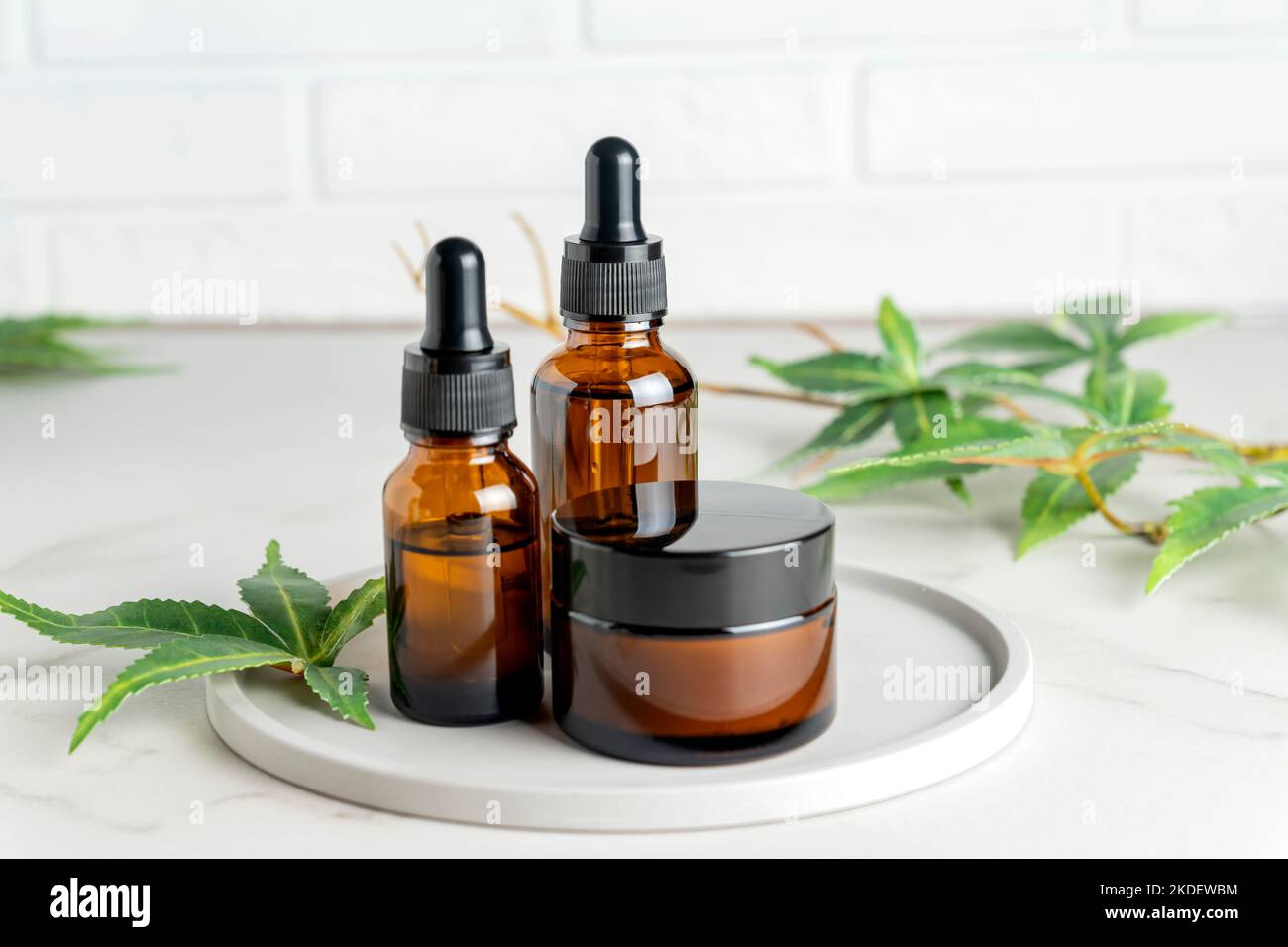 Hemp cbd oil serum in glass dropper bottles with cannabis leaves ...
