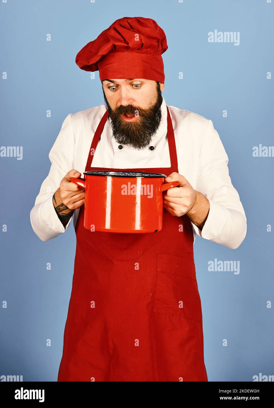 Kitchen utensils concept. Man with beard holds kitchenware Stock Photo ...