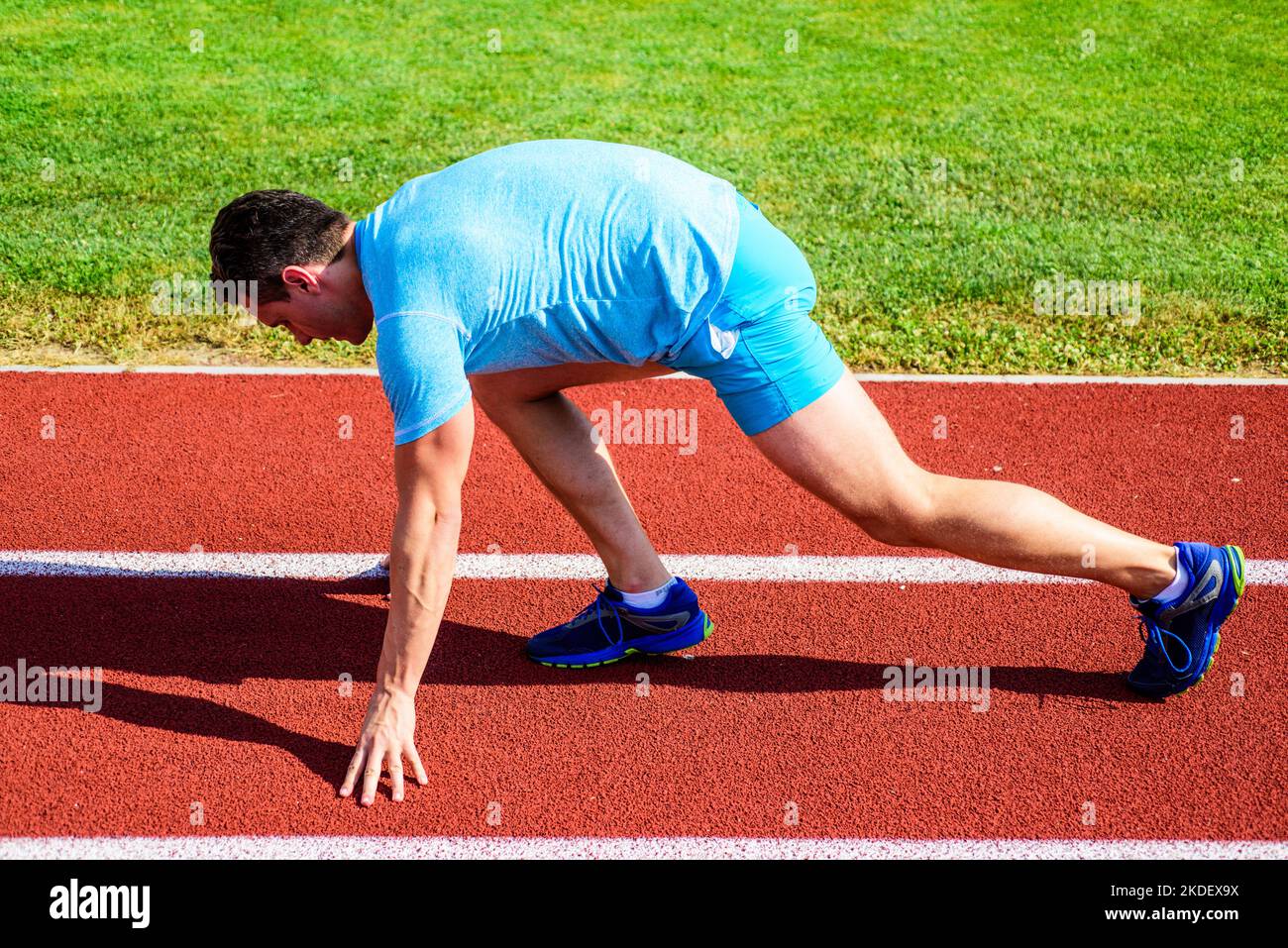 Make effort for victory. Man athlete runner stand low start position ...