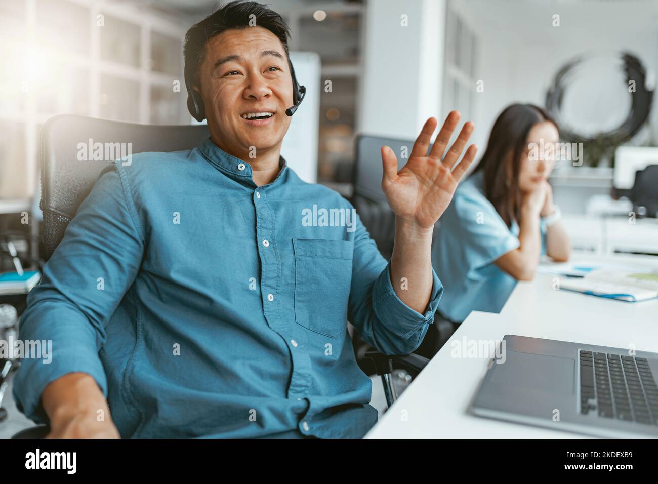 Smiling asian businessman talking phone with client while sitting in ...