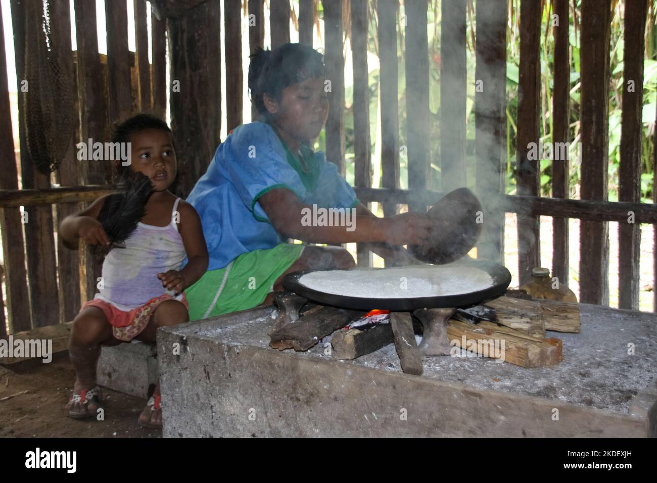 Woman demonstrates preparing and cooking yucca root tortillas in an ...