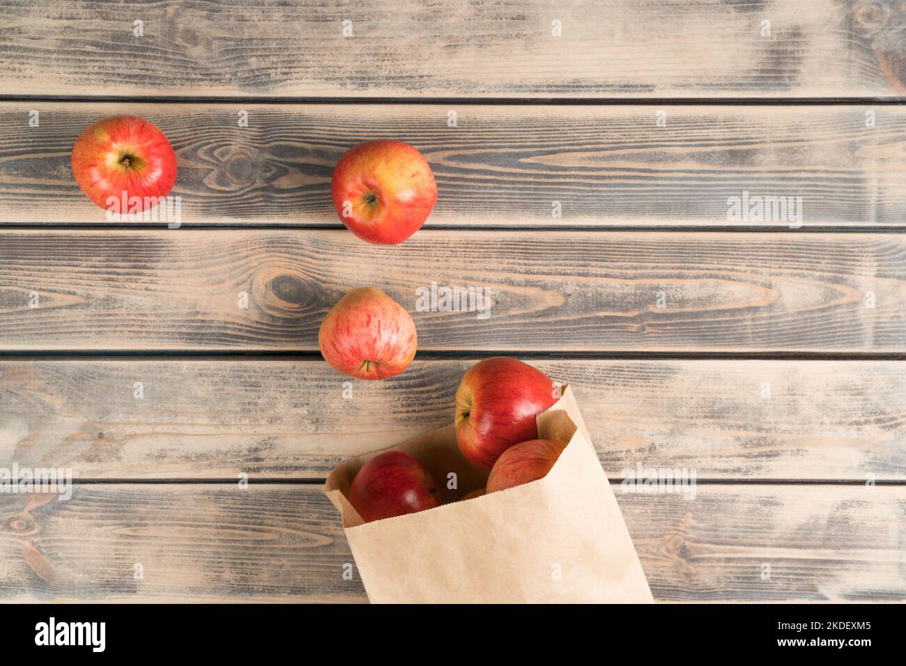 Bunch of fragrant sweet red apples on faded wooden table, top view ...