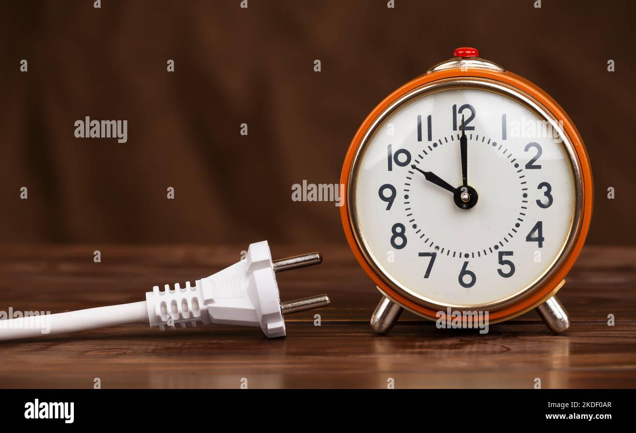Electrical plug with an alarm clock. Energy saving, electricity, save ...
