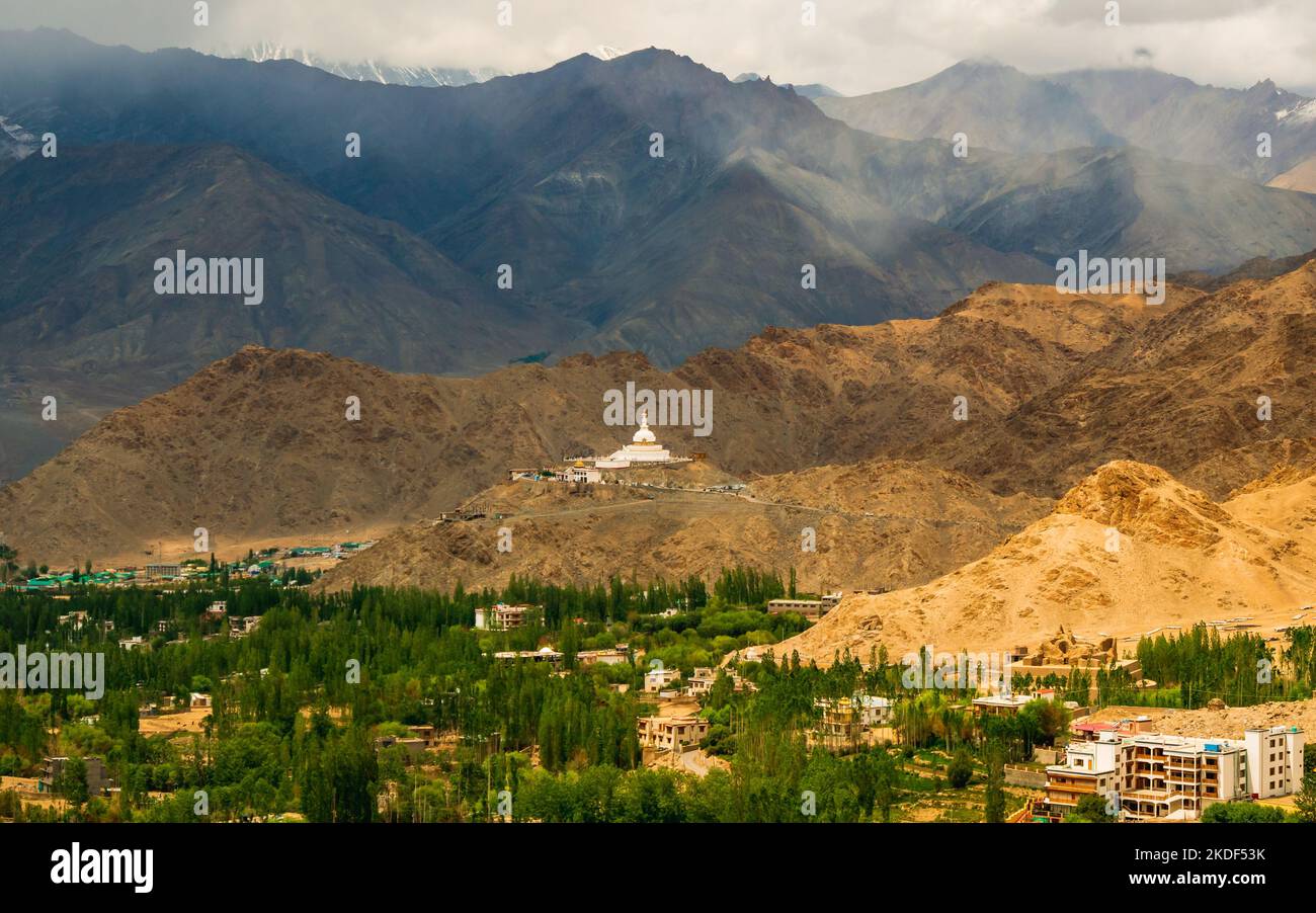 Shanti Stupa is a Buddhist white-domed stupa surrounded by mountains ...